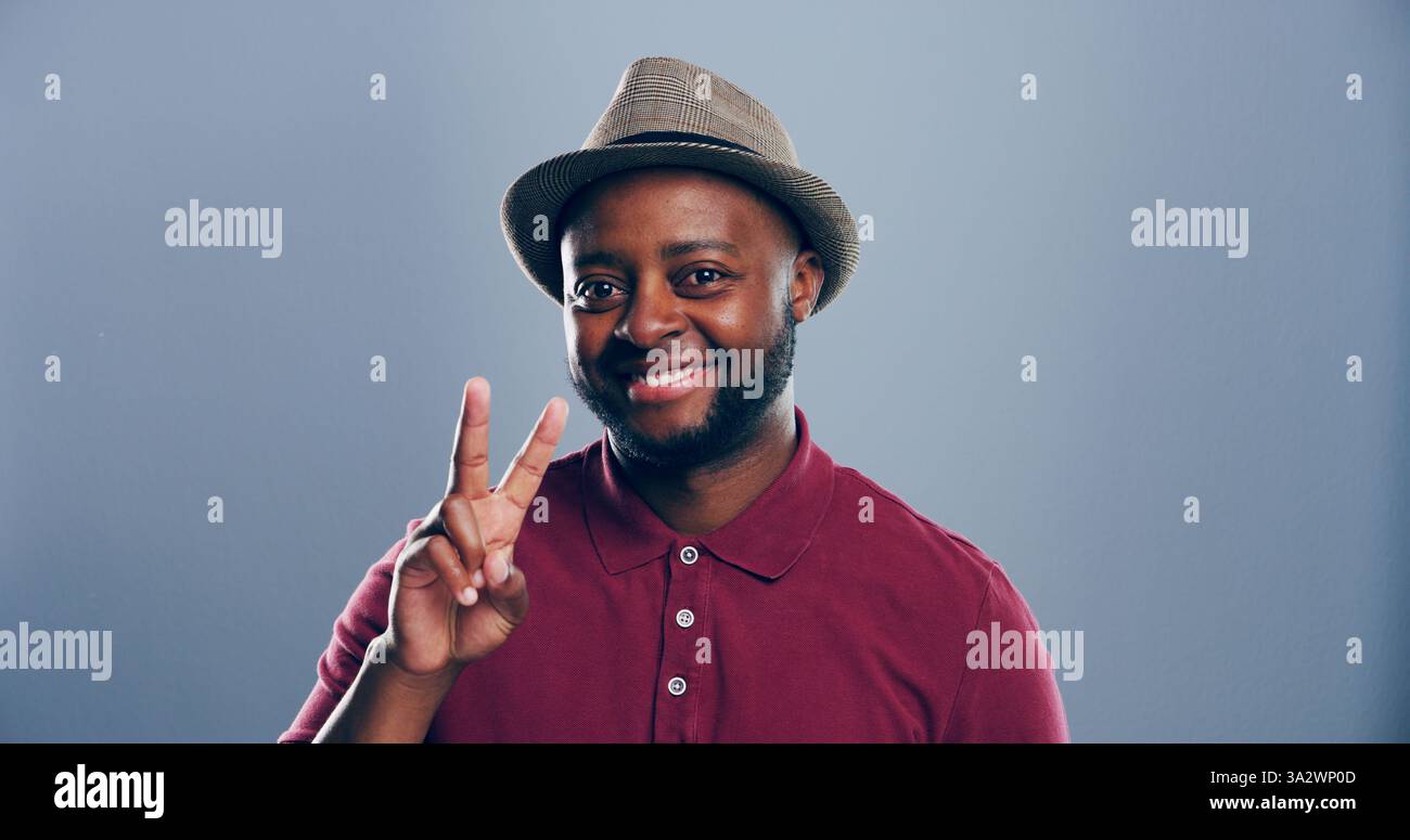 Portrait, space and black man with peace sign in studio with positive ...