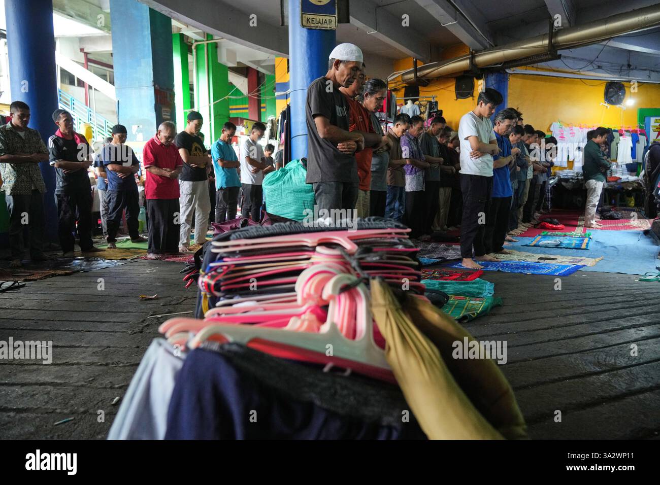 Muslim men perform Friday prayer during Ramadan, at Tanah Abang market ...
