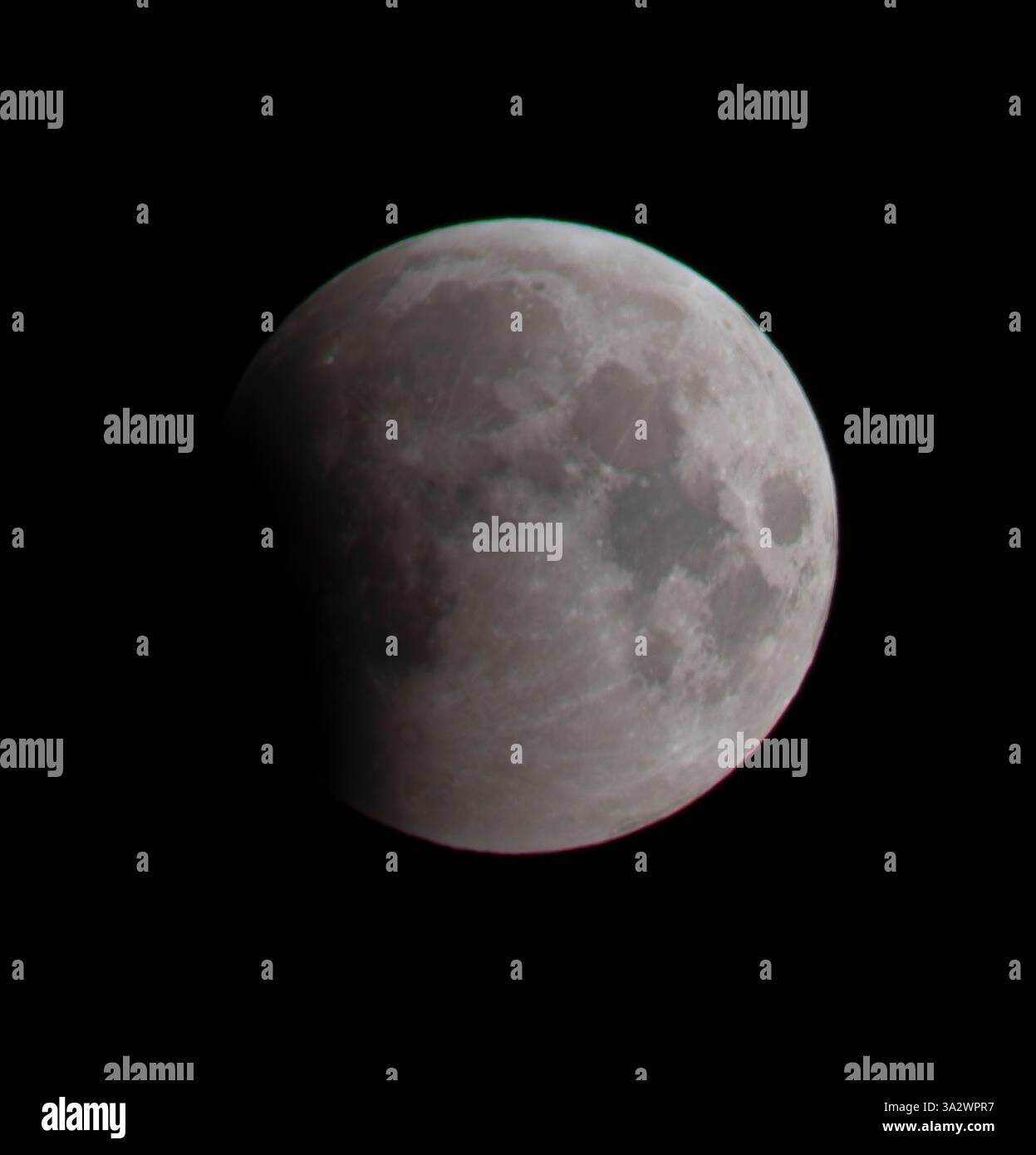 London, UK. 14th Mar, 2025. The partial lunar eclipse in progress ...