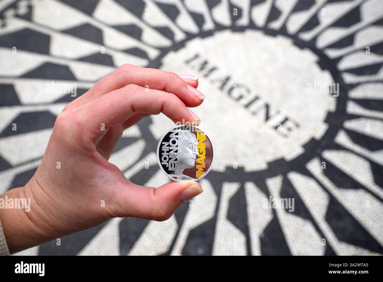 EDITORIAL USE ONLY A collectable coin featuring John Lennon and the ...