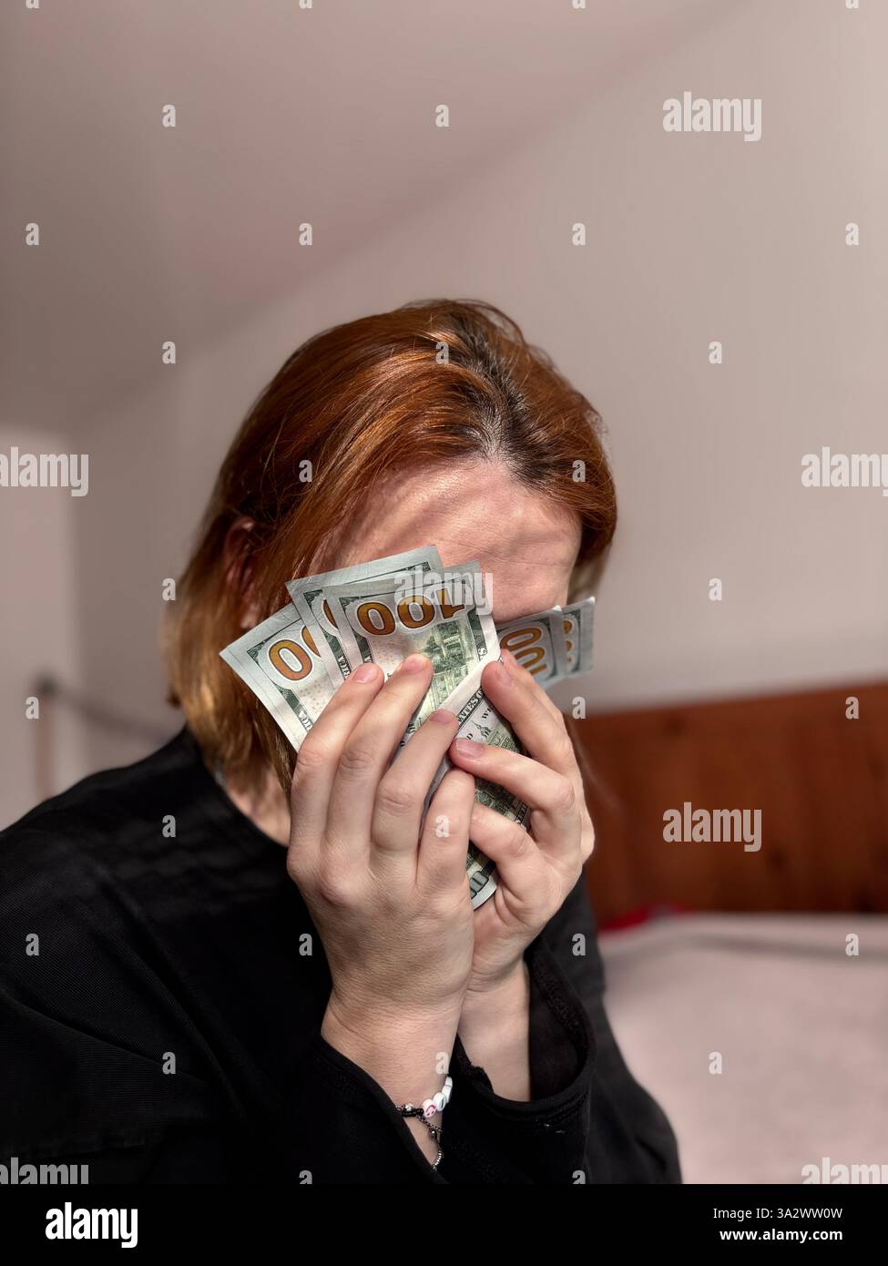 A girl is crying, wiping her tears with dollars . High quality photo ...