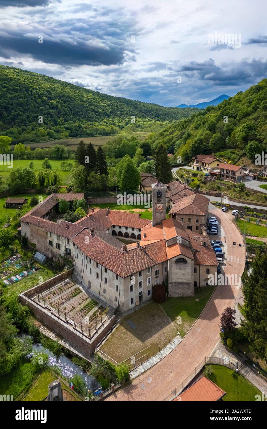 Aerial view of the ancient Badia di San Gemolo in Ganna on a spring day ...