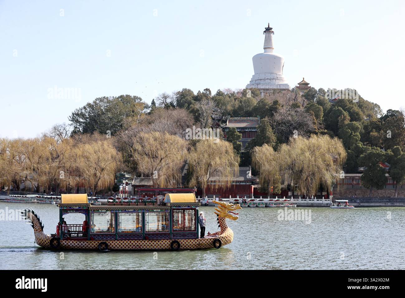 Tourists admire spring scenery on sightseeing boats at Beihai Park in ...