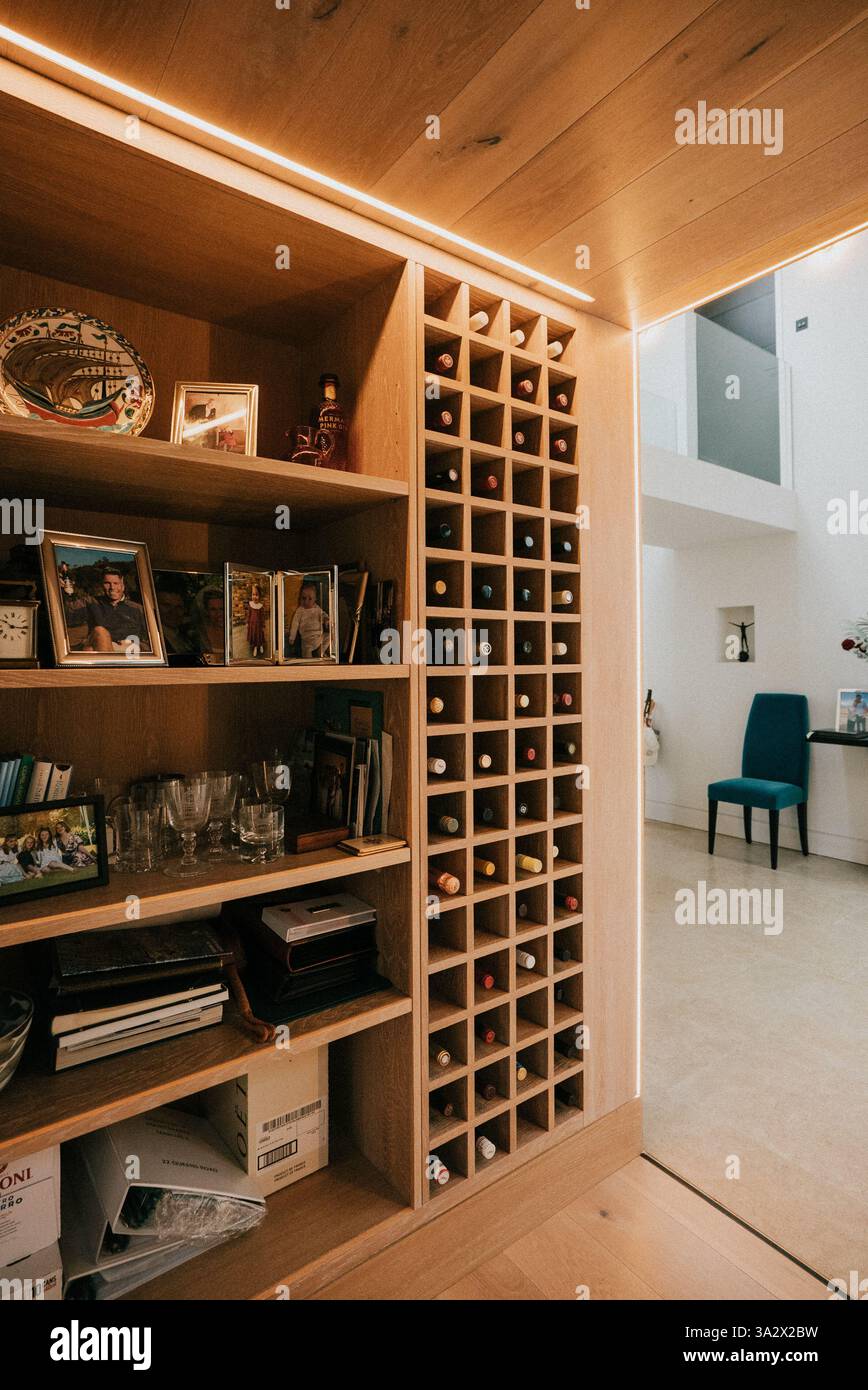 A wine cellar with a shelf full of books and a chair. The wine cellar ...