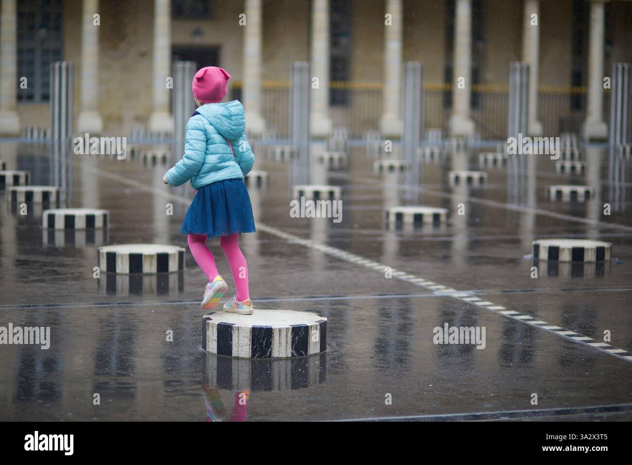 Adorable preschooler girl playing in Palais Royal garden. Child having ...