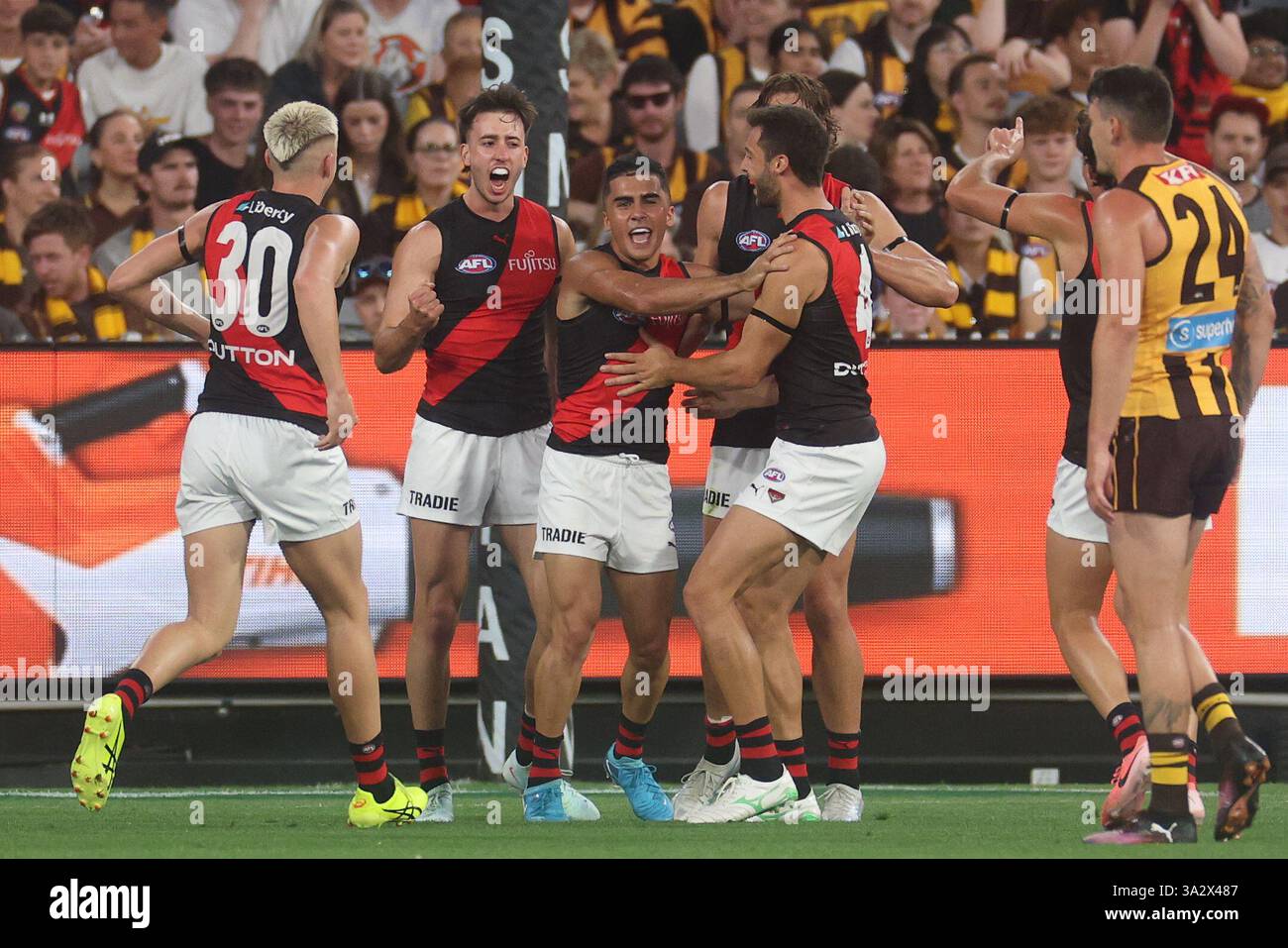 Isaac Kako of the Bombers (centre) celebrates kicking a goal during the ...