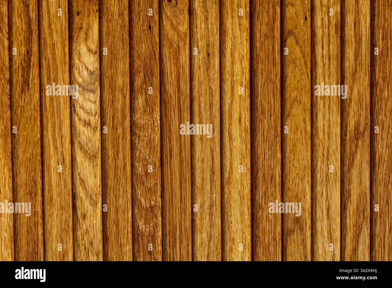 A close-up of vertically stacked narrow wooden planks, placed parallel ...