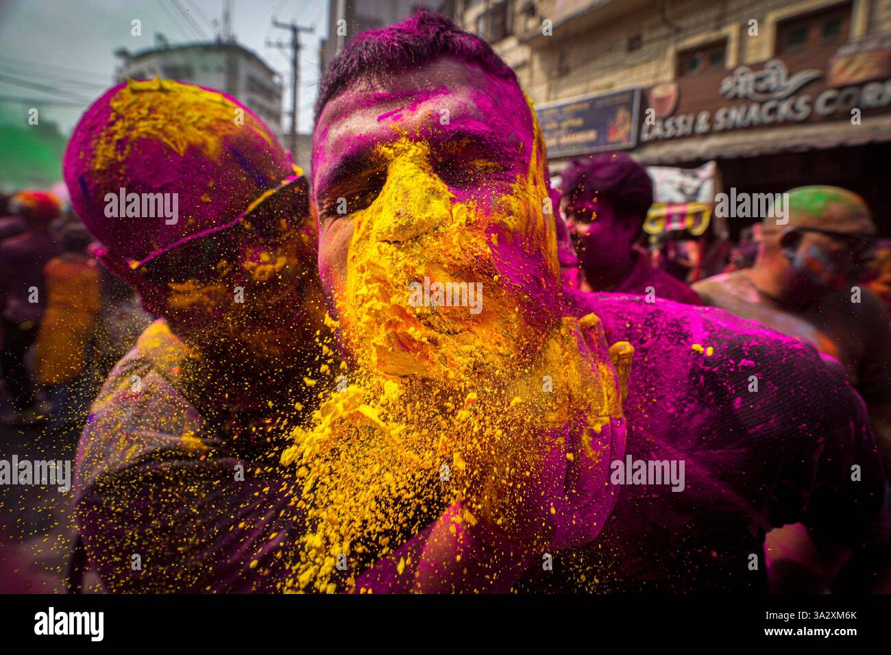 People apply color powder on each other as they celebrate Holi festival ...