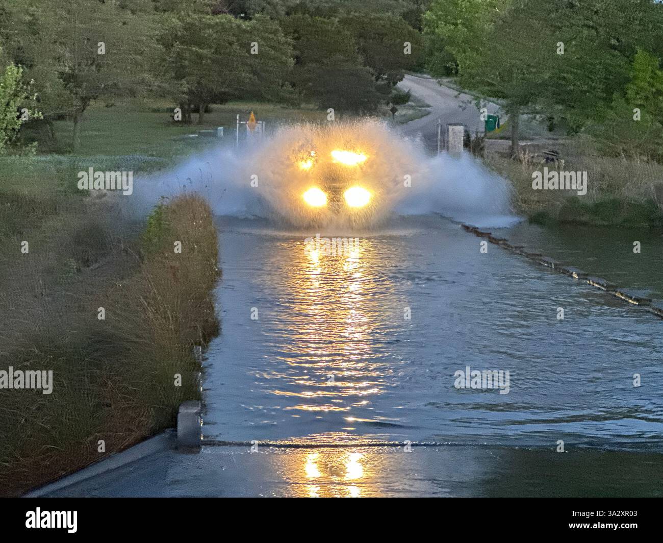 Truck speeds through low water crossing in central Texas Stock Photo ...