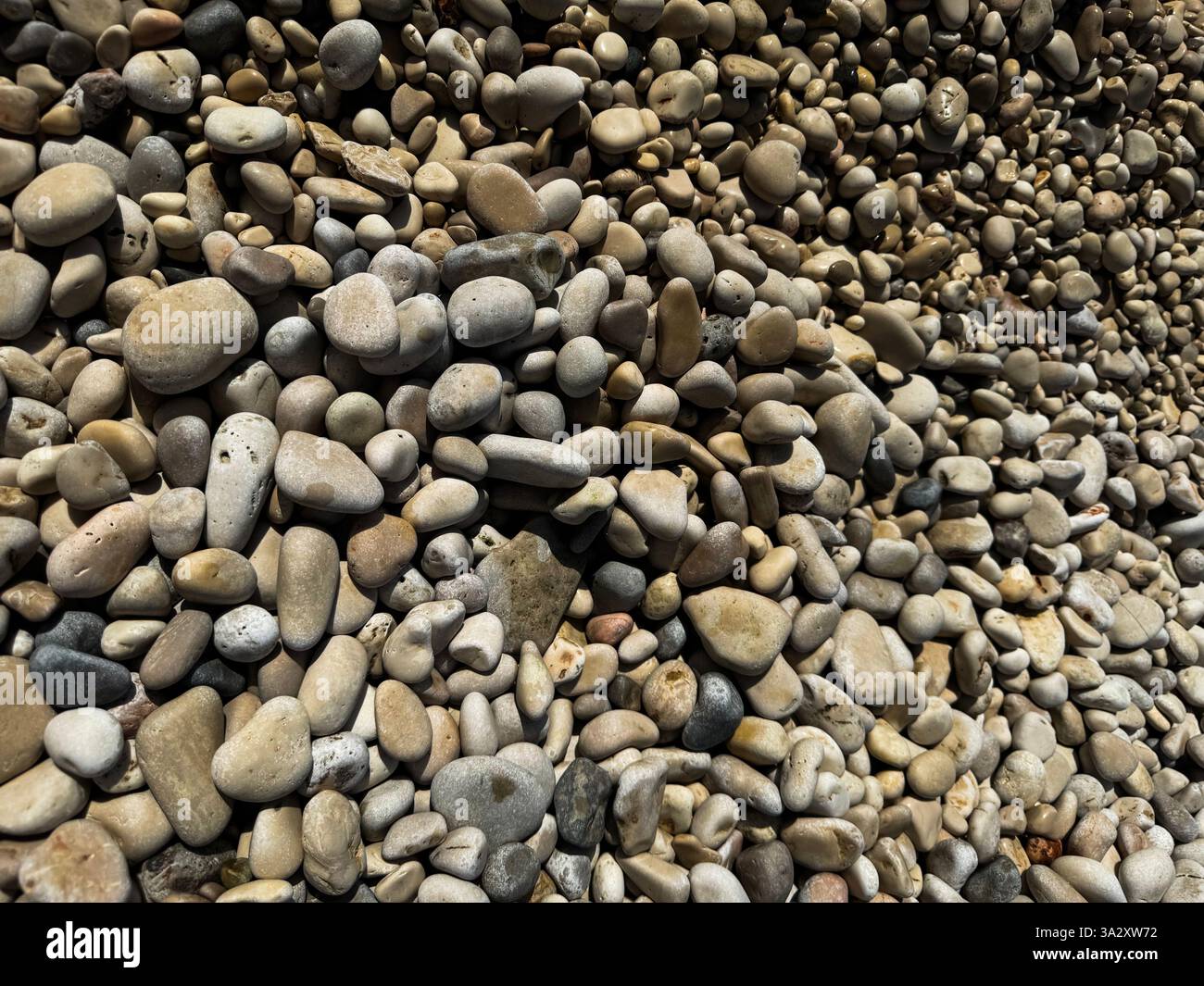 Close-up view of a diverse arrangement of smooth stones showcasing ...