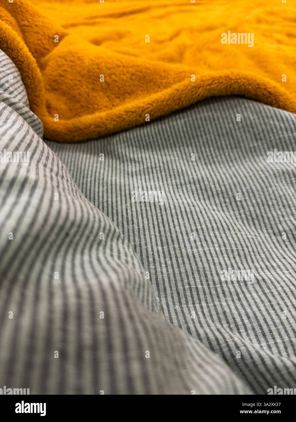 A soft, textured bedding display showcases cozy materials in a calming ...