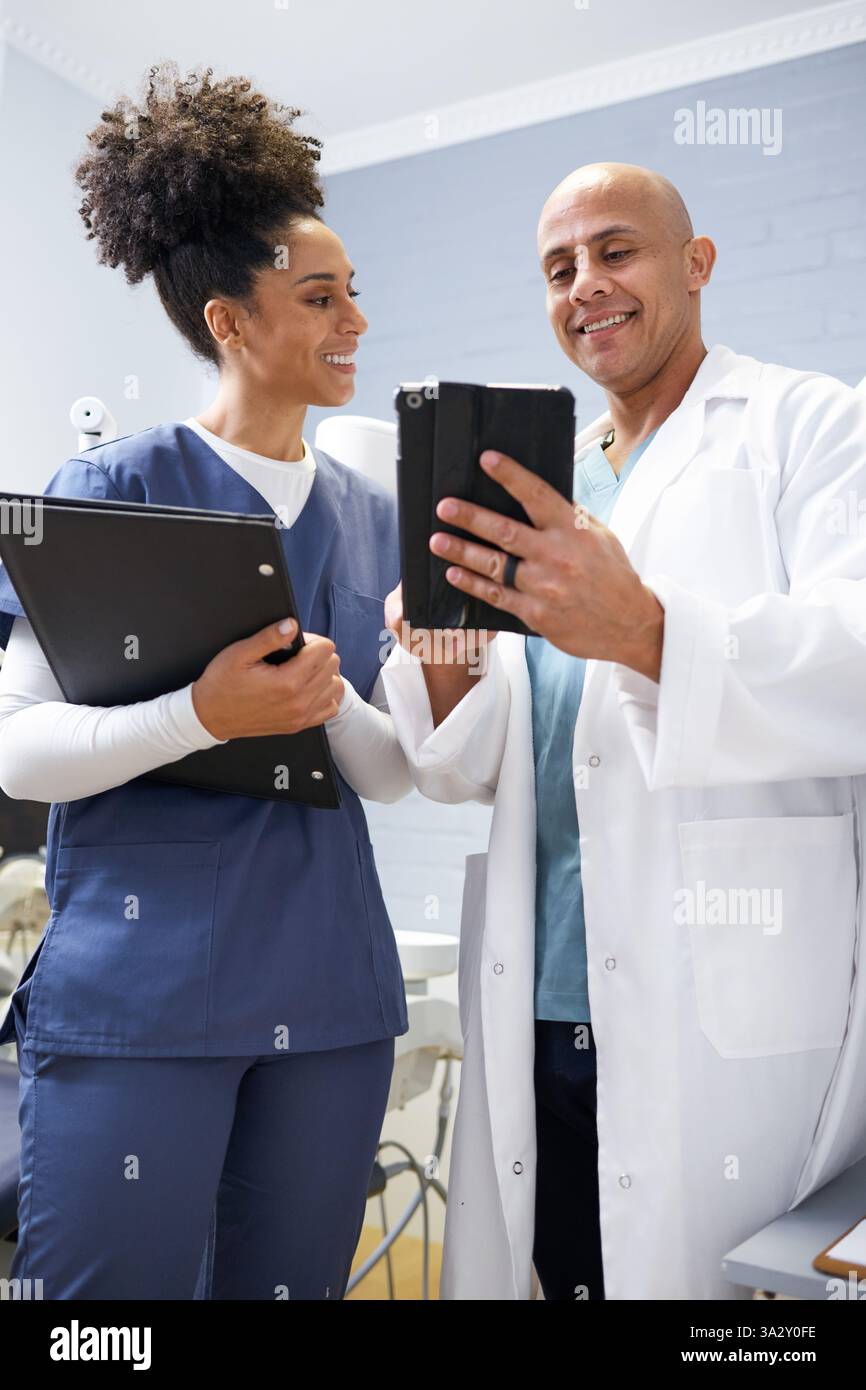 Medical Professionals Collaborating Using Technology in a Modern Clinic ...