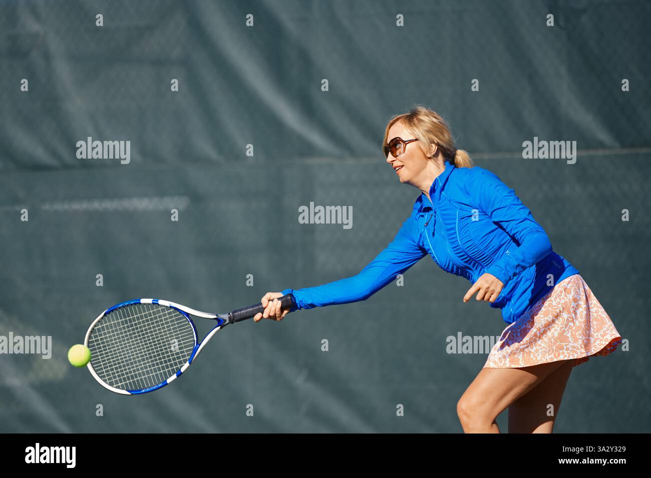 Woman practicing tennis at the tennis court Stock Photo - Alamy