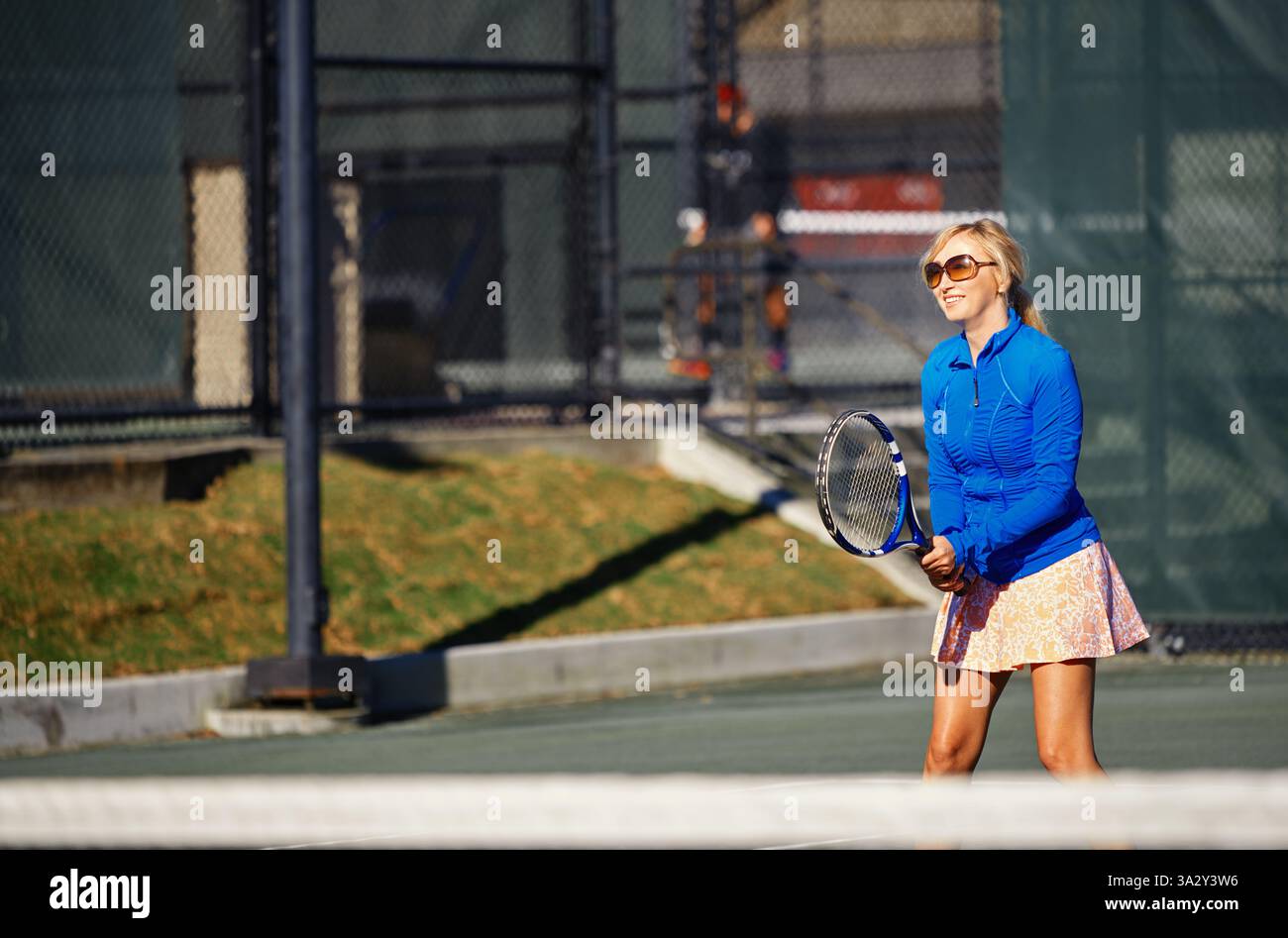 Woman practicing tennis at the tennis court Stock Photo - Alamy