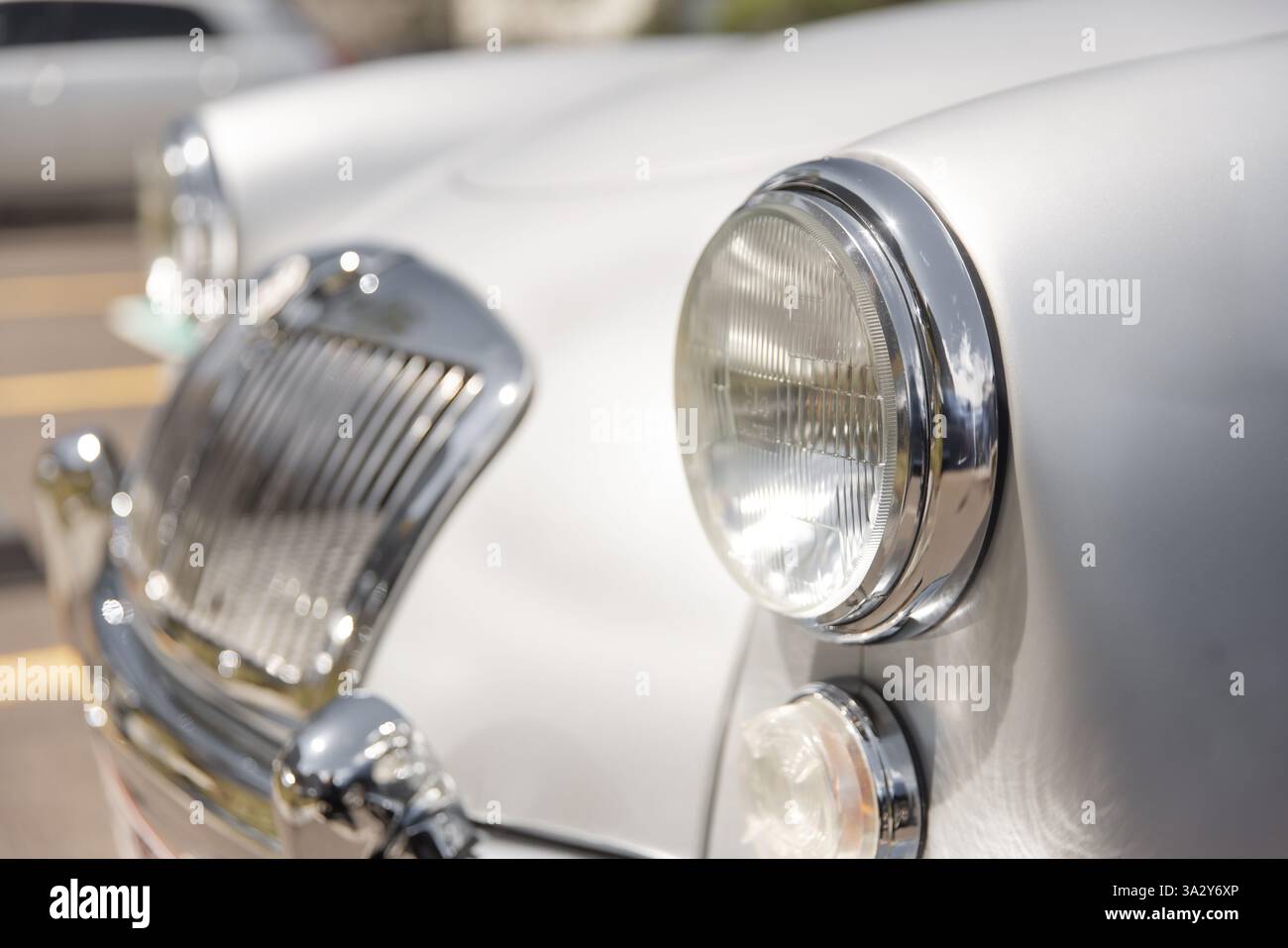 Front of vintage sports car headlight and grille on pearl white Stock Photo - Alamy