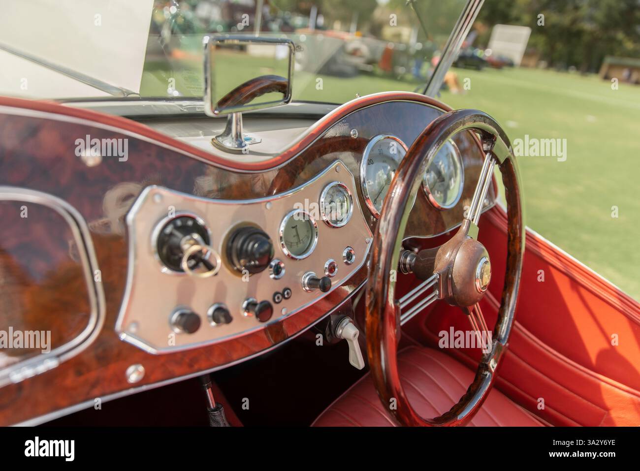 Classic convertible interior with wooden dashboard and red leather ...