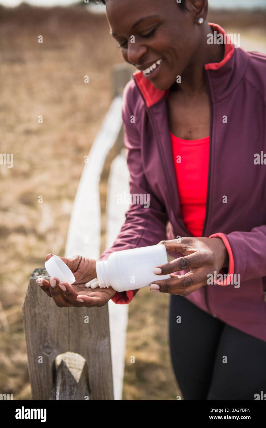 Woman on coastal outdoor run with dietary supplement Stock Photo - Alamy