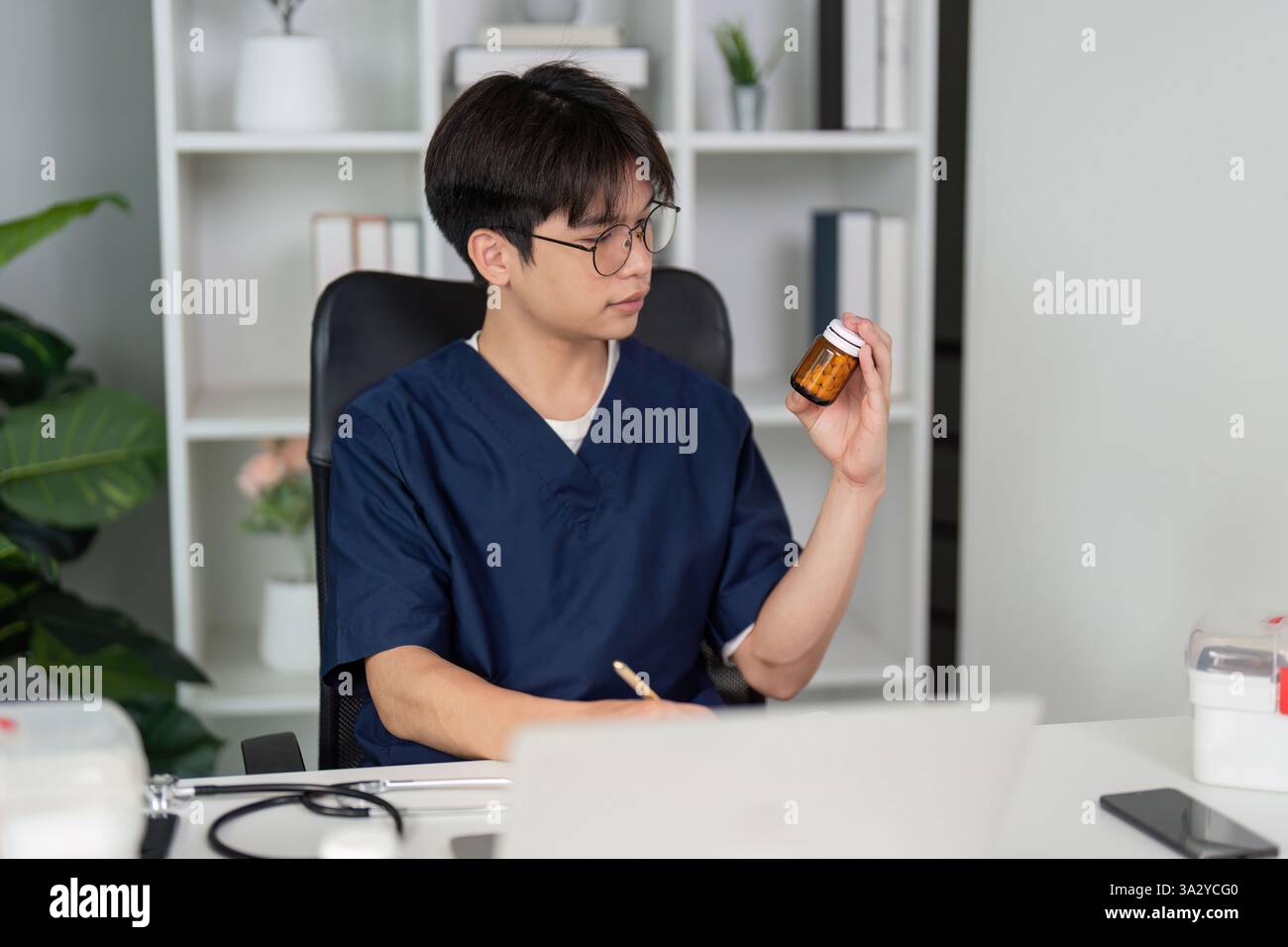 Research and Inquiry. A medical student analyzing medication while ...