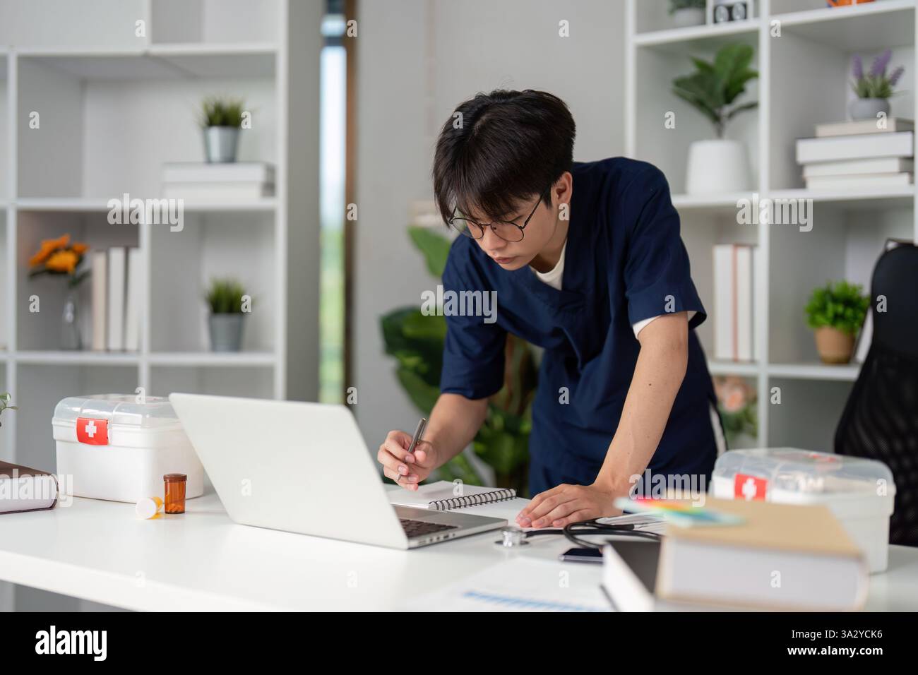 Focused Evaluation and Academic Growth. A medical student leans over a ...