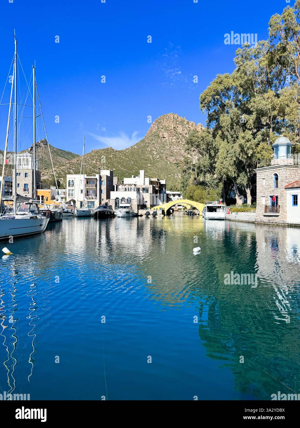 Scenic harbor with boats and charming buildings under a clear blue sky ...