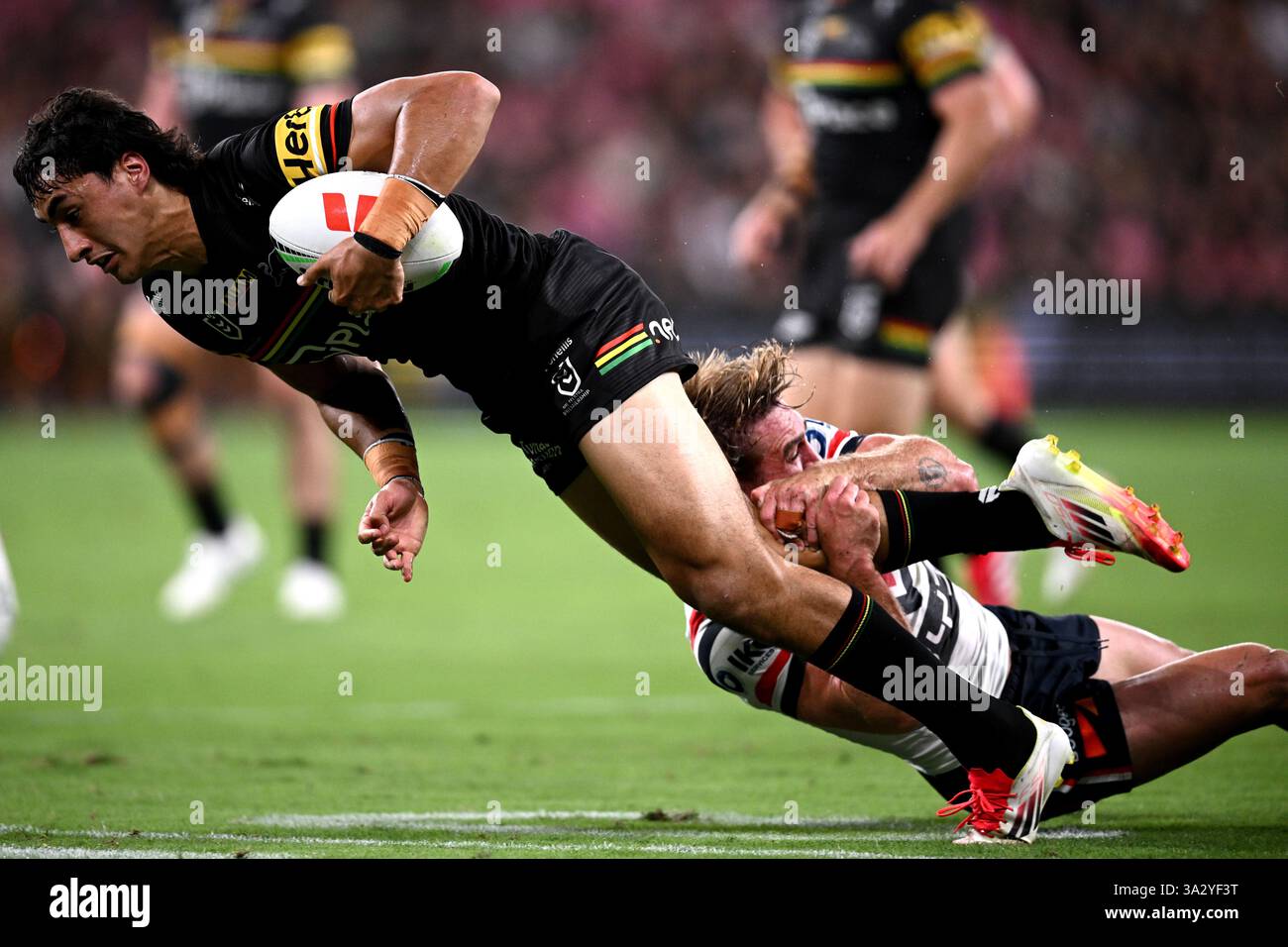 Casey McLean of the Panthers is tackled by Connor Watson of the ...