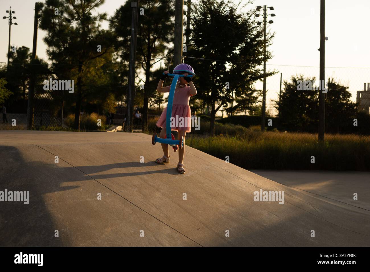 Child Prepares To Ride Down Ramp at Gathering Place Skate Park Stock ...