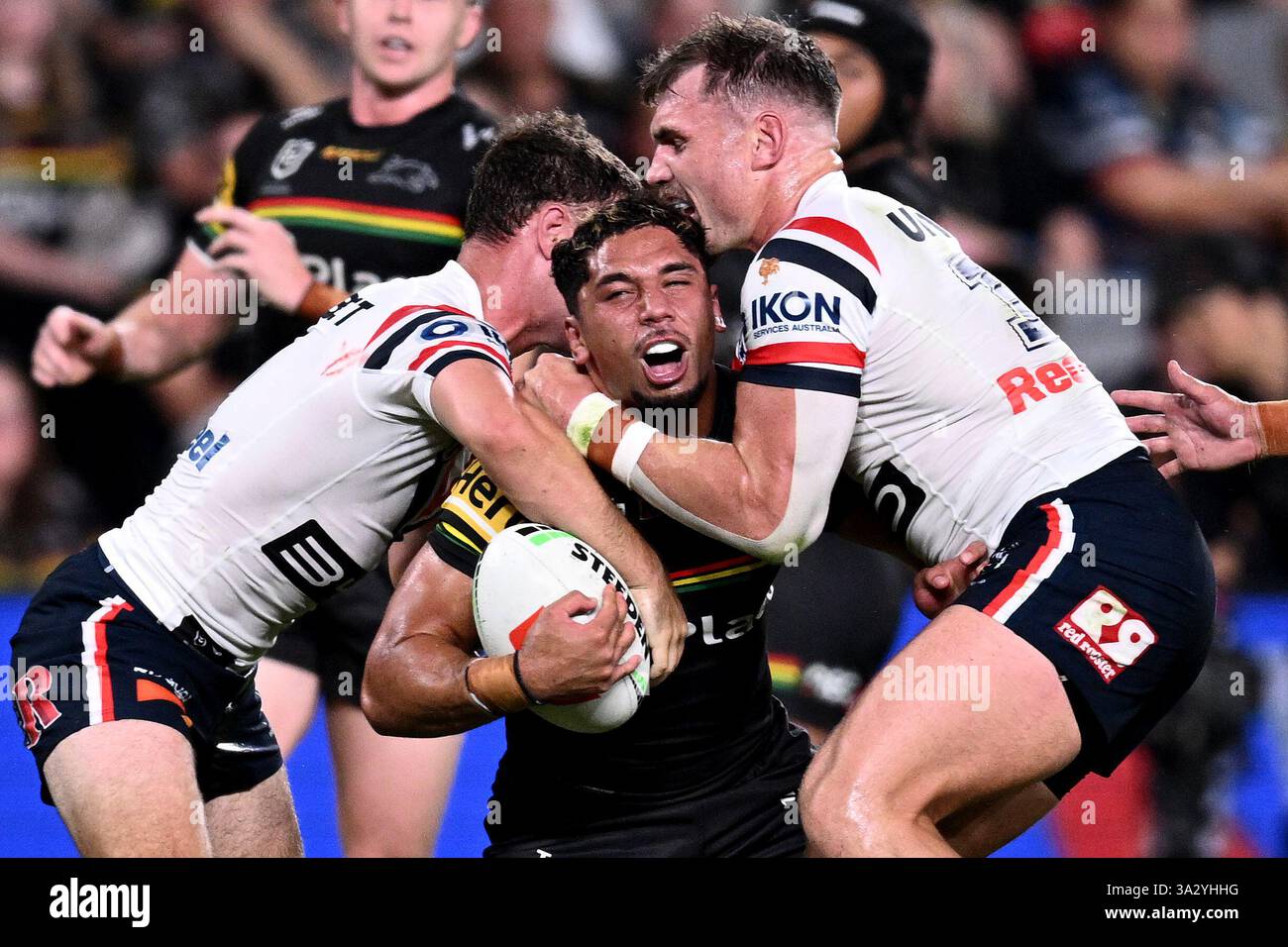 Izack Tago of the Panthers is tackled by Sandon Smith (left) and Angus ...