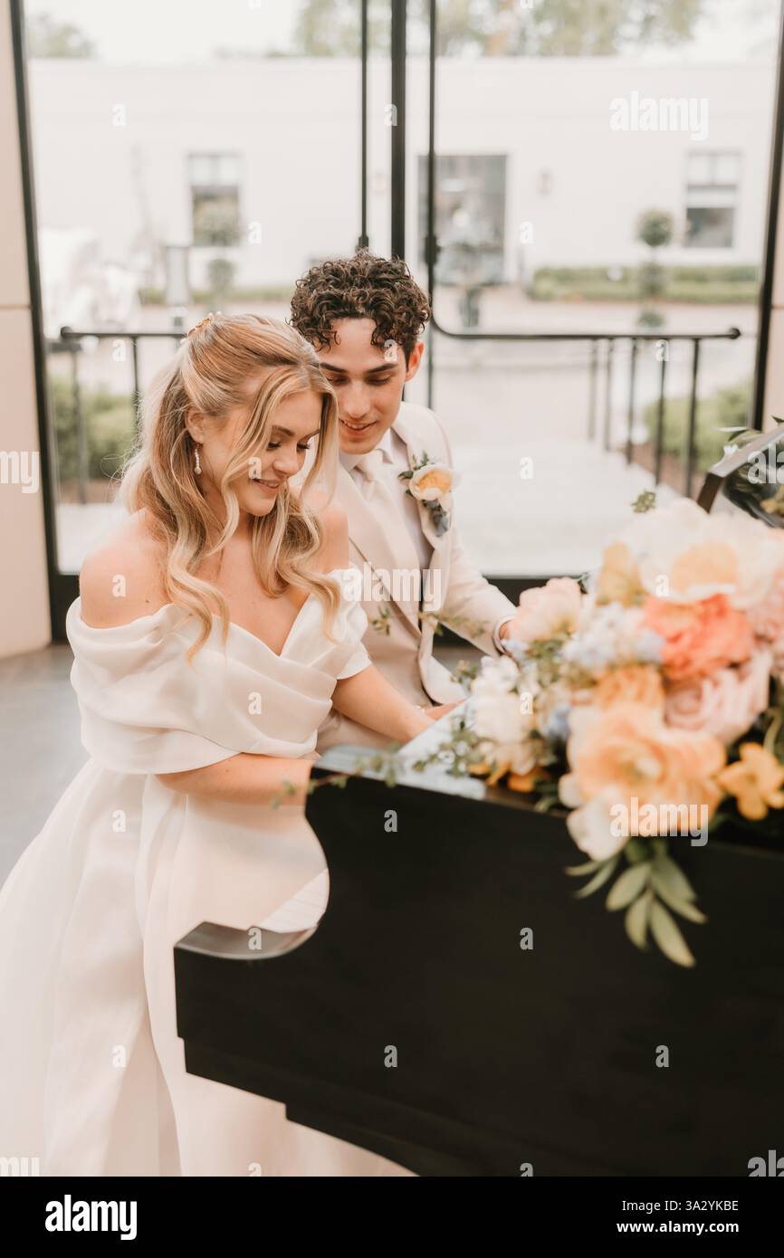 Bride and groom share a joyful moment playing a grand piano together ...