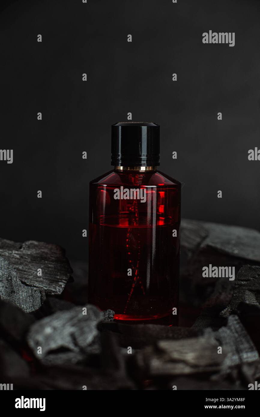 Red perfume bottle on dark background Stock Photo - Alamy
