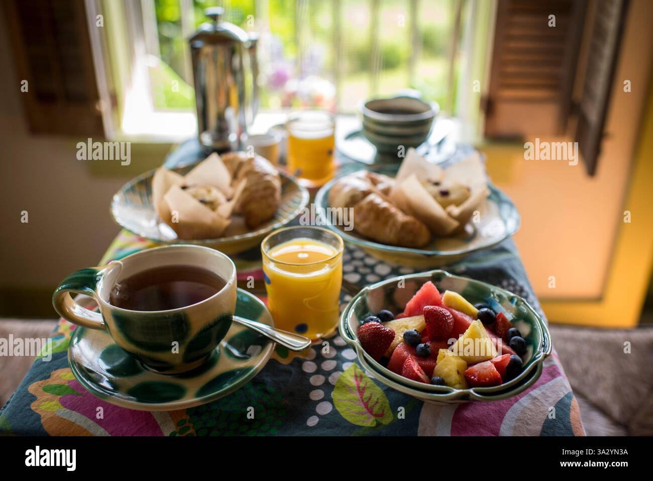 Cozy Breakfast with Fresh Pastries and Fruit Stock Photo - Alamy