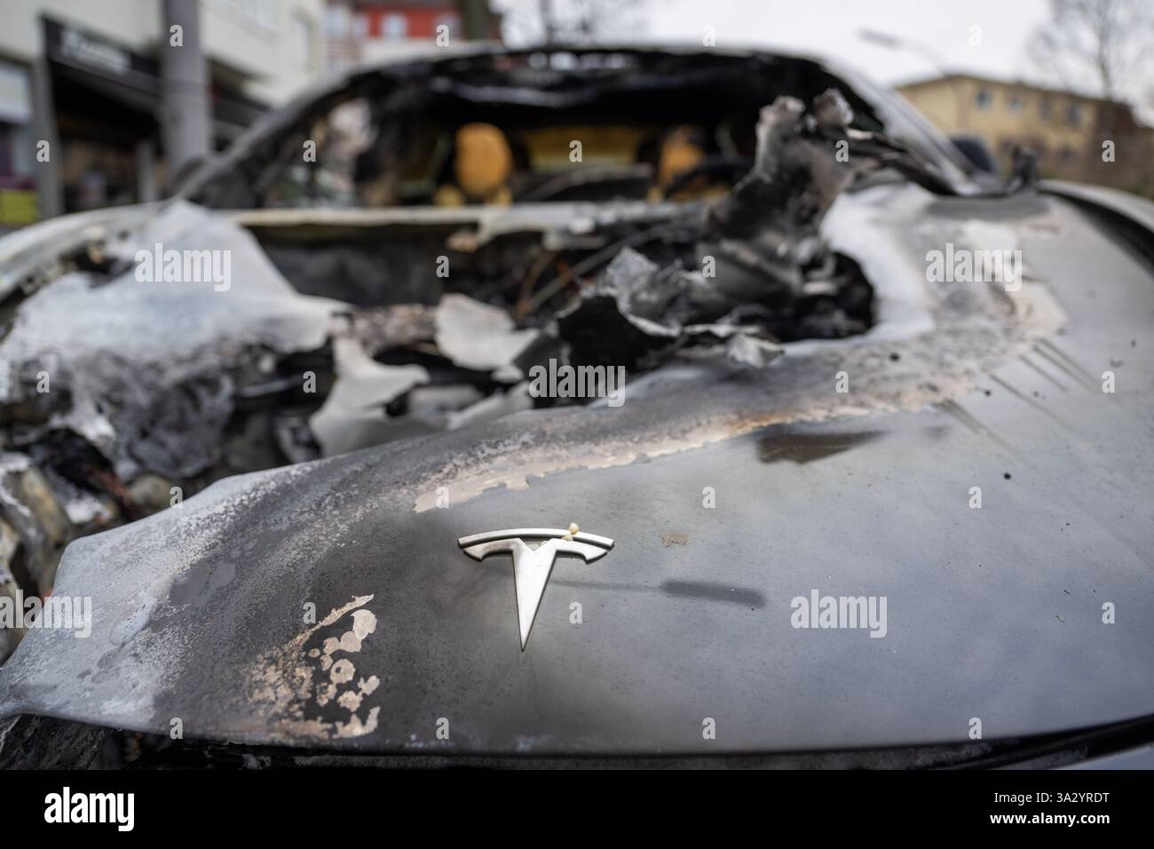 Berlin, Germany. 14th Mar, 2025. A burnt-out Tesla car stands in the ...