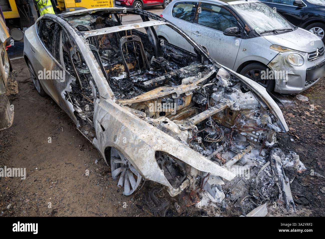 14 March 2025, Berlin: A burnt-out Tesla car stands in the Steglitz ...