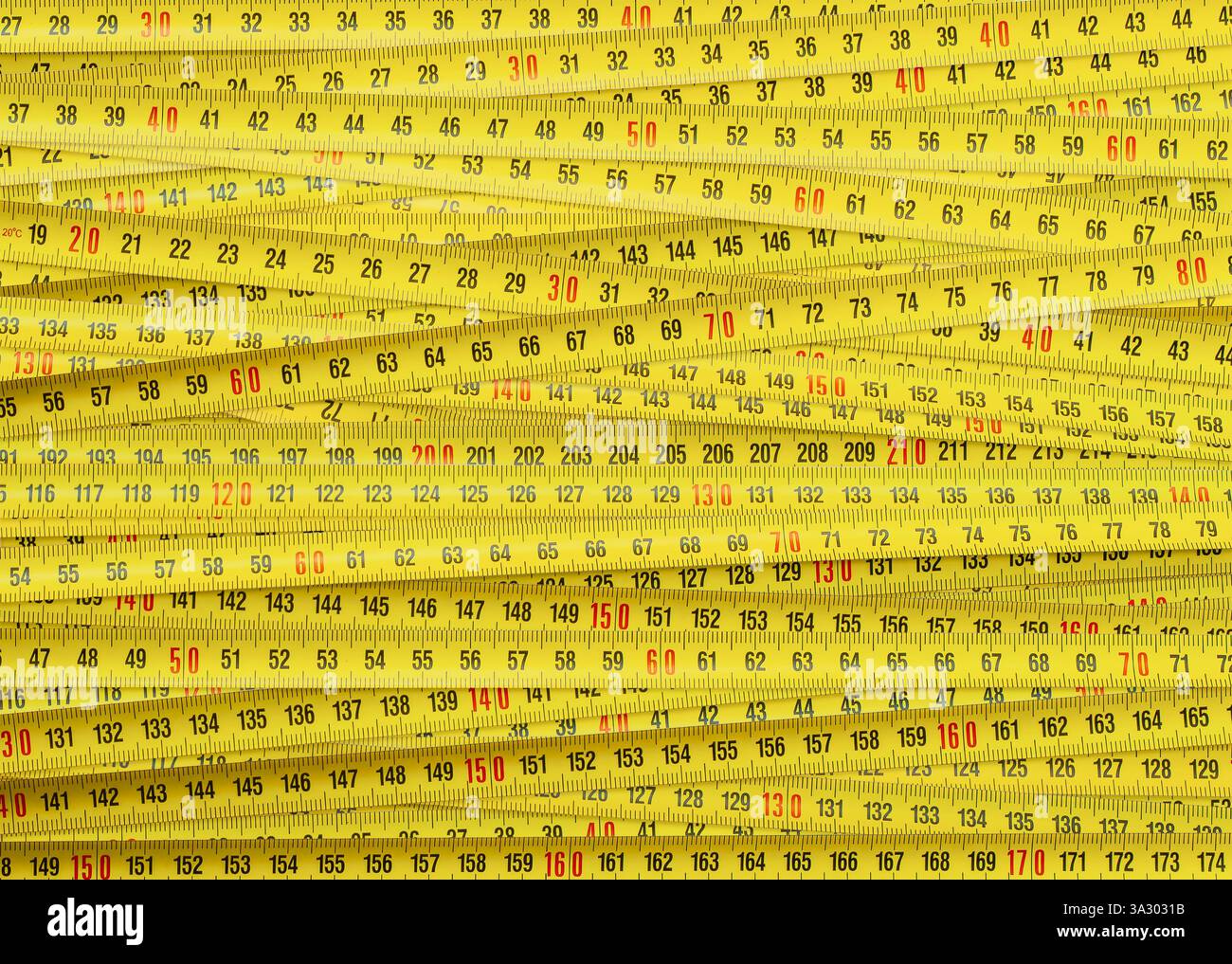 Сomposition of multiple yellow construction tape measures in metric ...