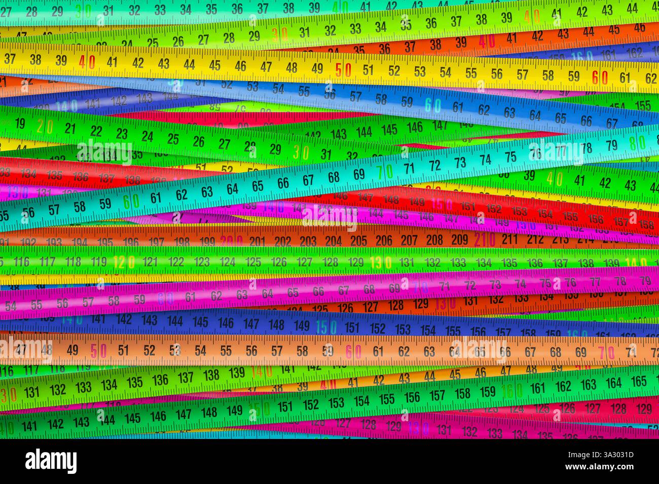 Arrangement of multiple construction tape measures in various colors ...