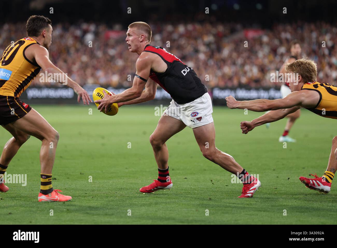 Ben Hobbs of the Bombers looks to handpassduring the AFL Round 1 match ...