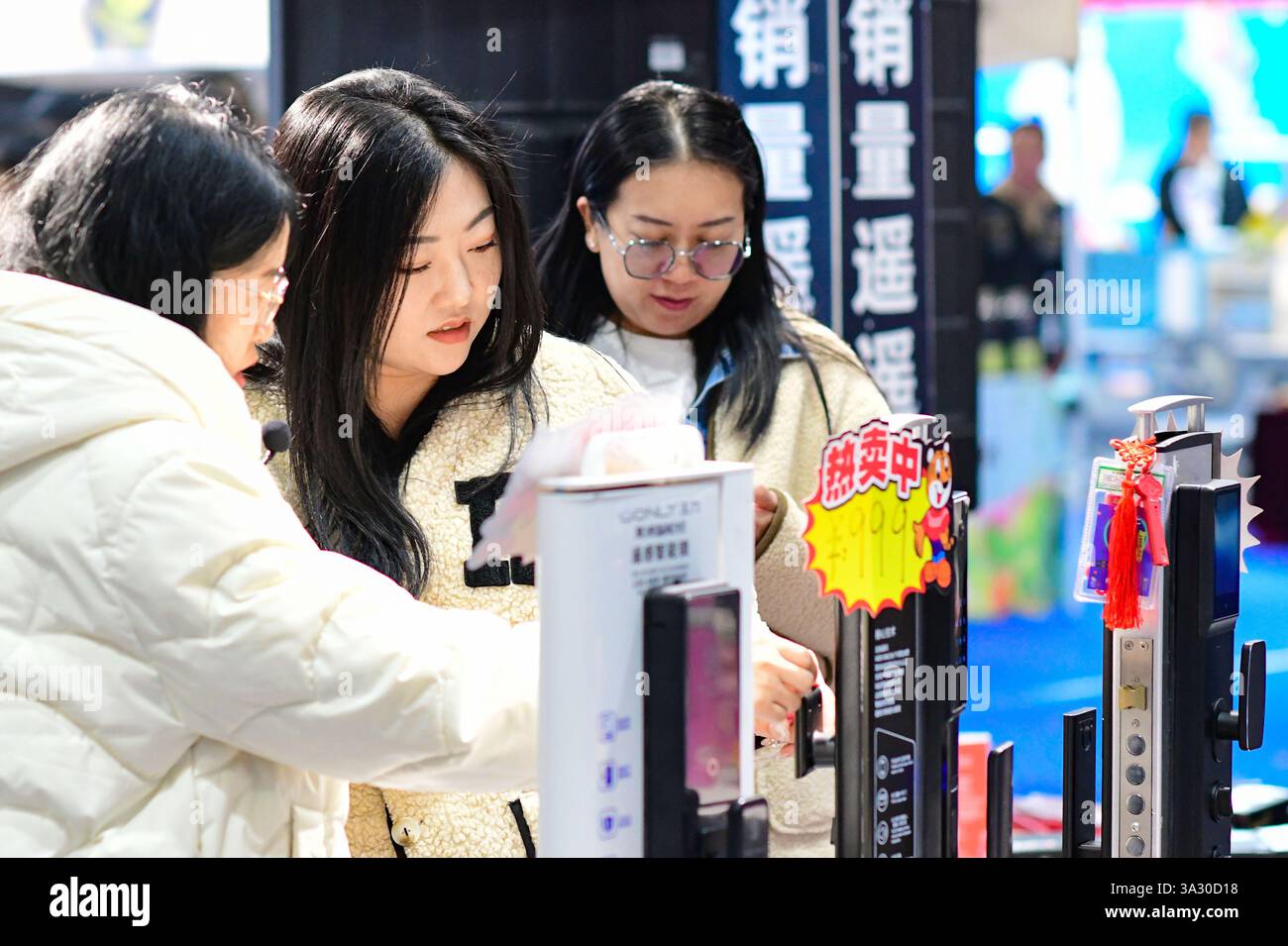 HOHHOT, CHINA - MARCH 14, 2025 - Visitors shop for smart door locks at ...