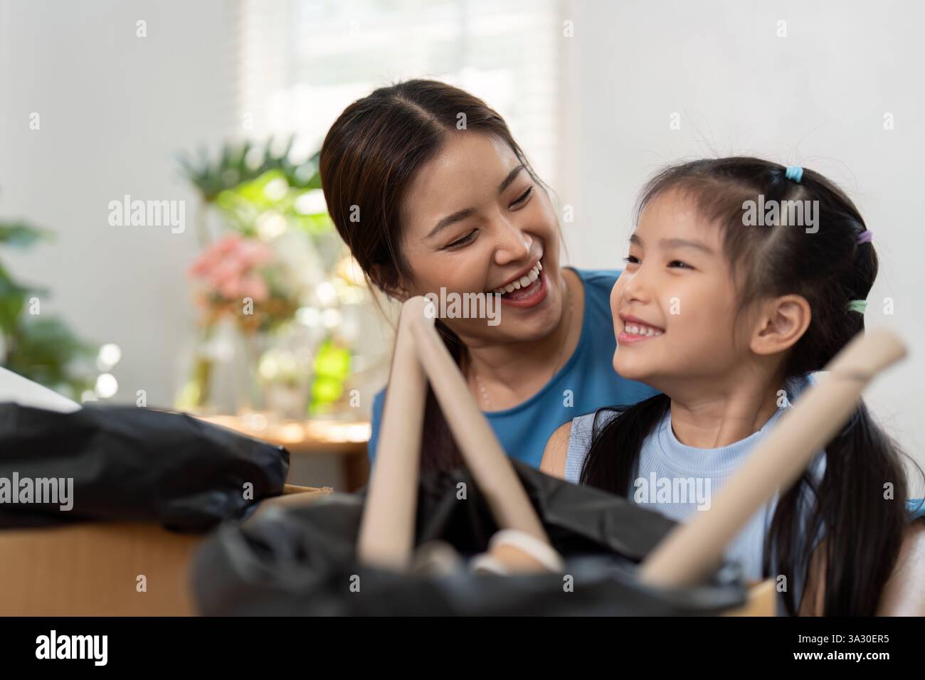 Family Engagement and Eco-education. A smiling mother teaches her ...