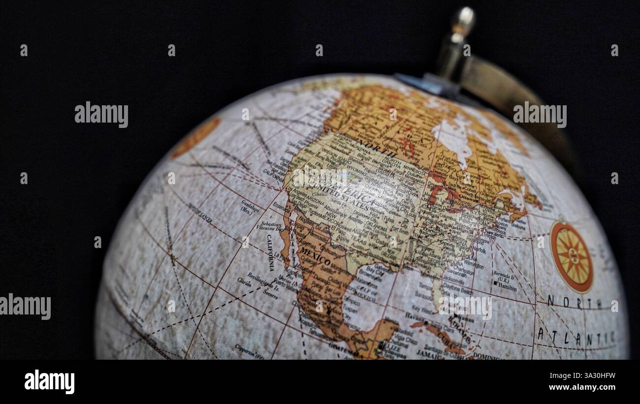 Table world Globe model in blue and brown color isolated on black ...