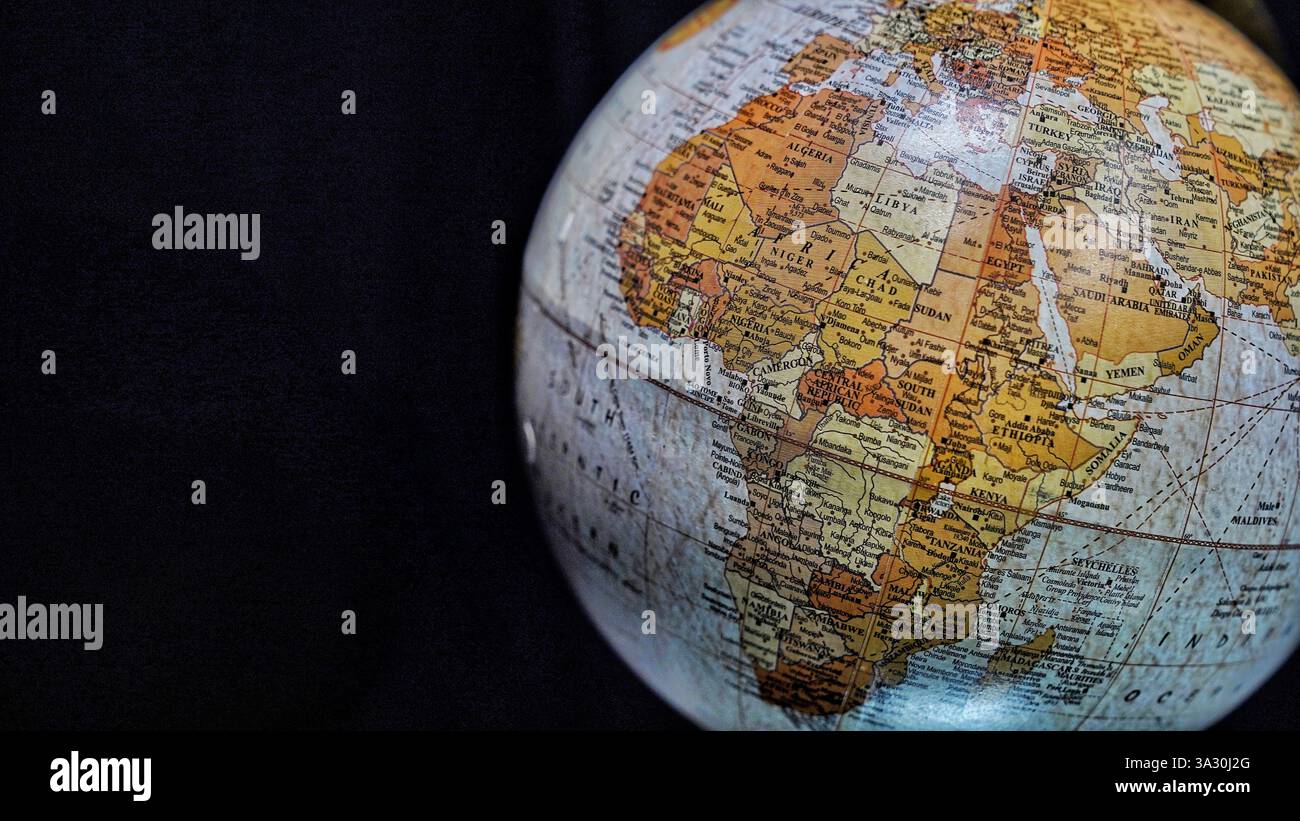 Table world Globe model in blue and brown color isolated on black ...