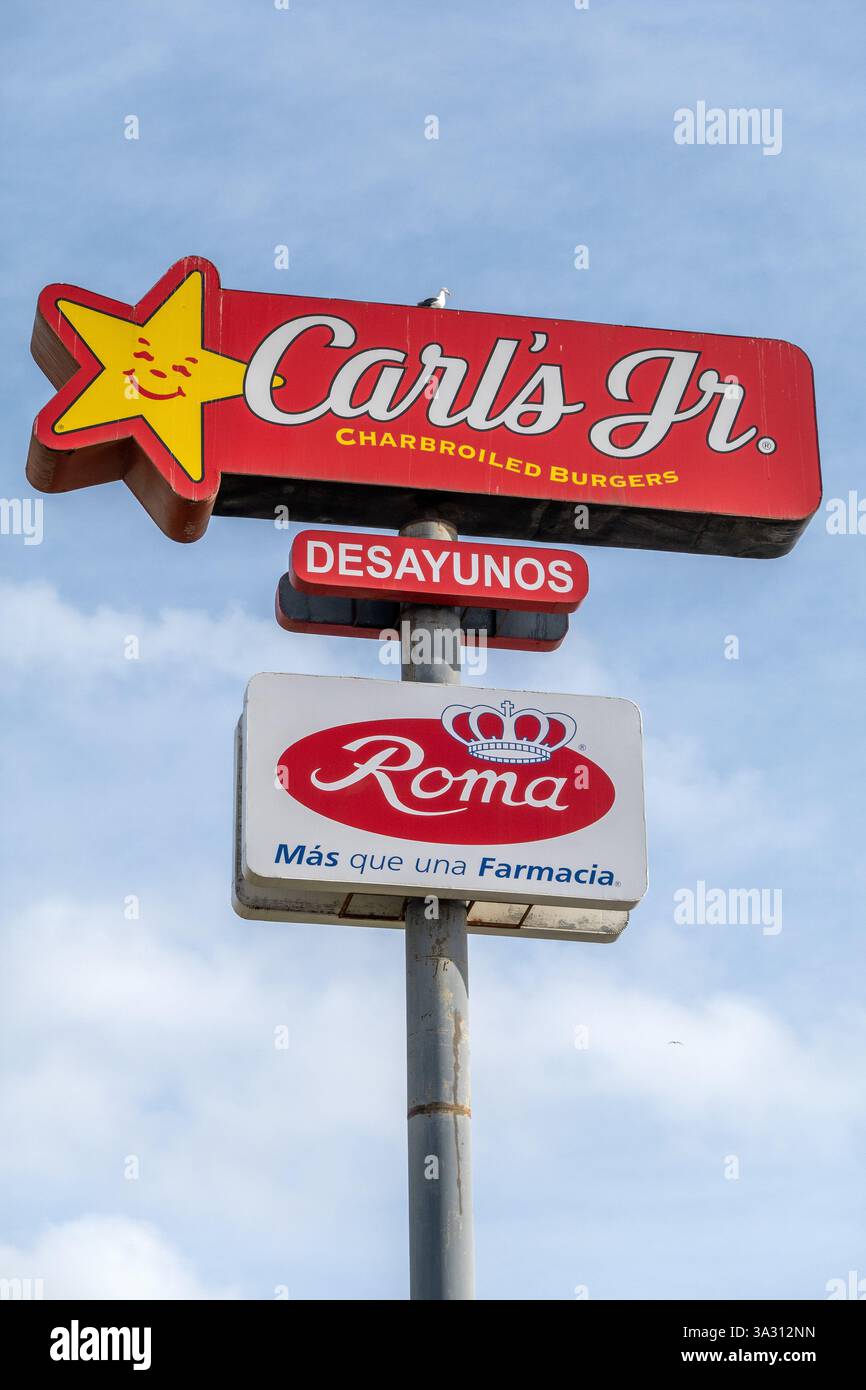 Carl's Jr Burger Fast Food Restaurant Sign Against A Blue Sky ...