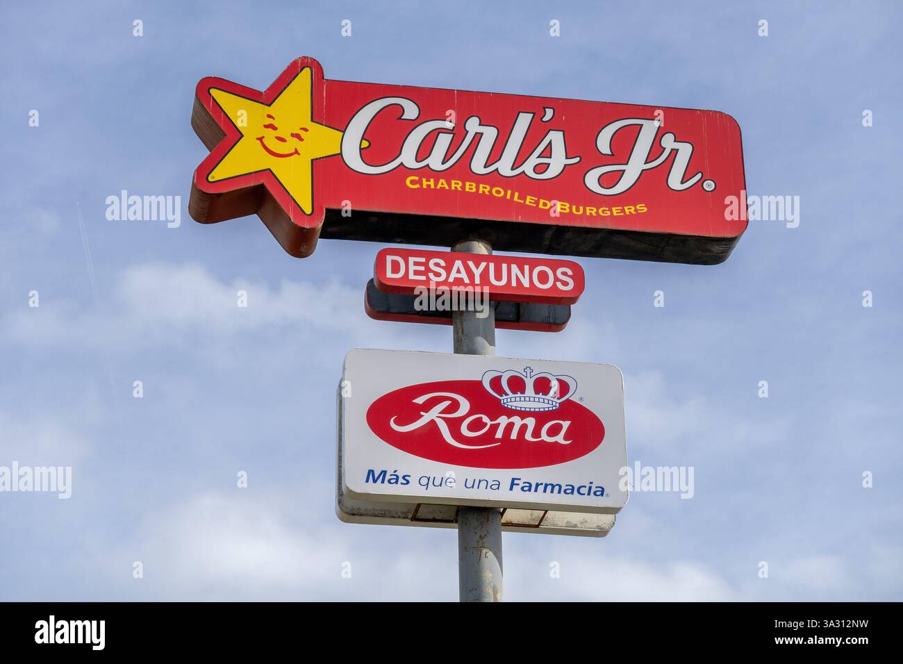 Carl's Jr Burger Fast Food Restaurant Sign Against A Blue Sky ...