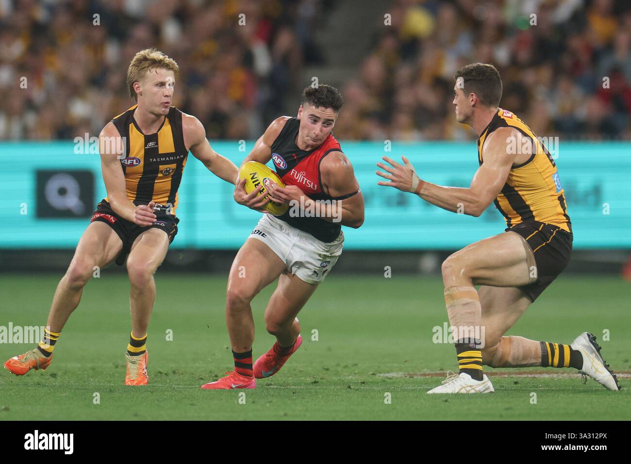 Elijah Tsatas of the Bombers runs with the ball during the AFL Round 1 ...