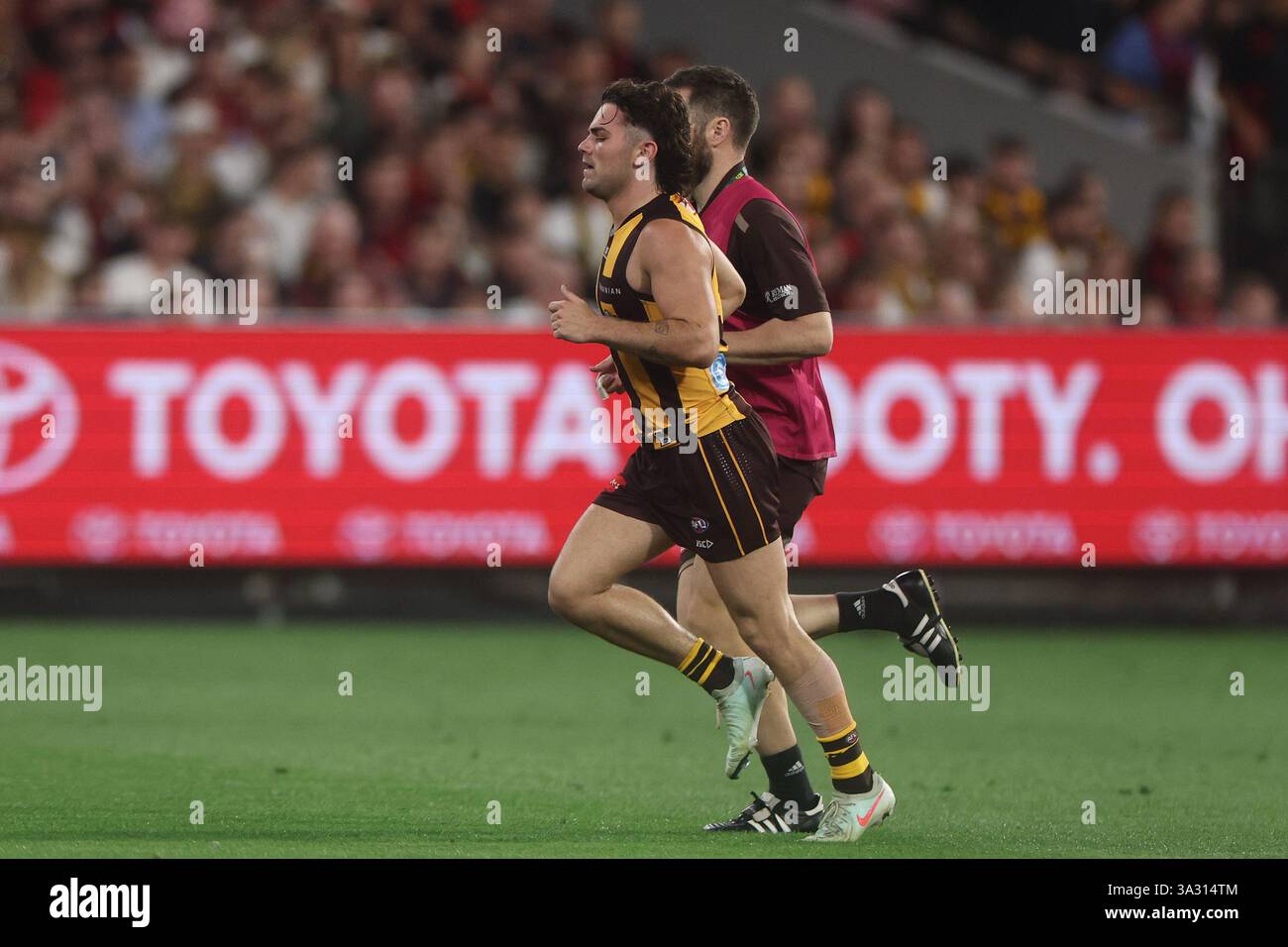 Nick Watson of the Hawks leaves the field after falling from a contest ...