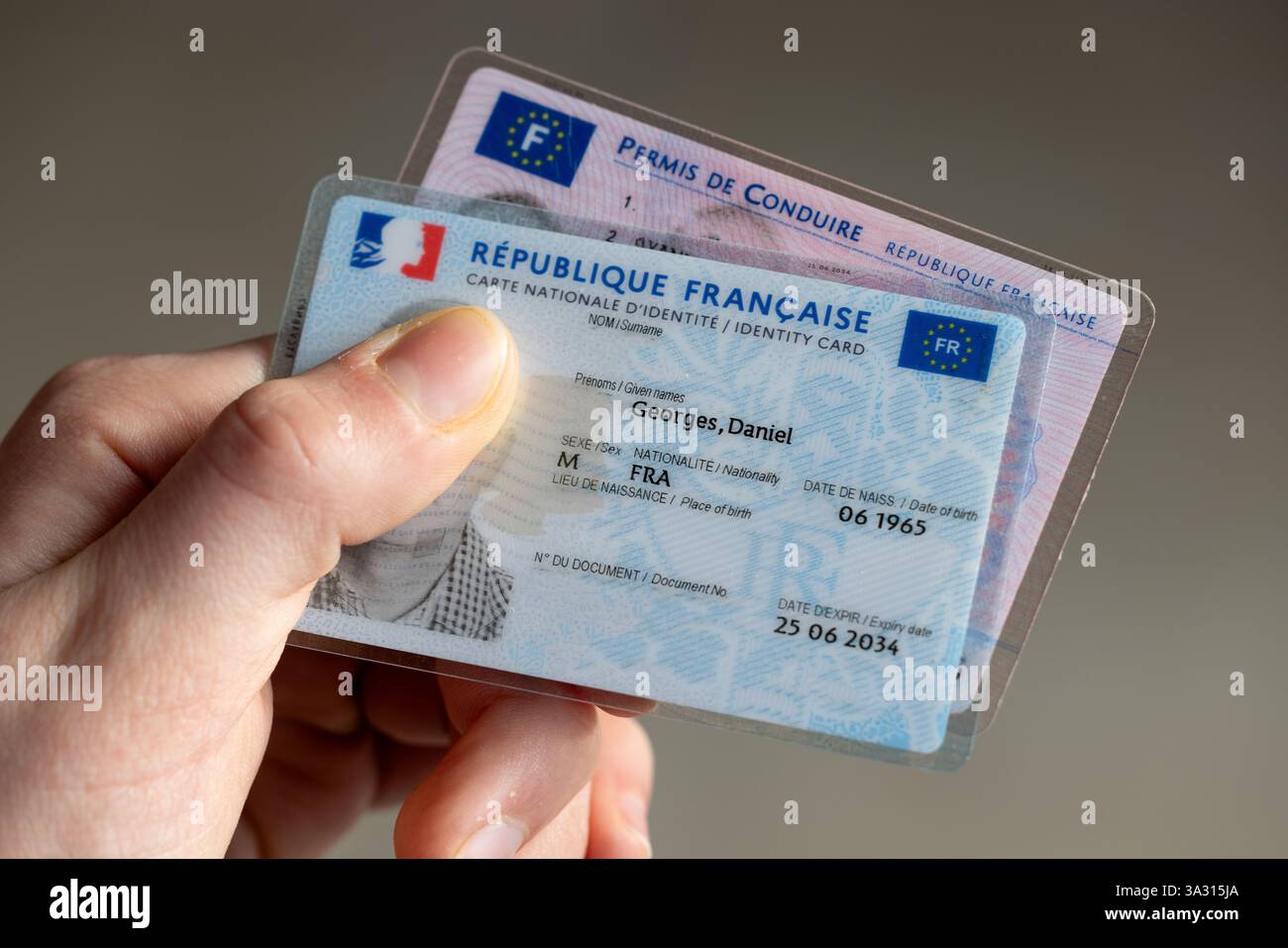 Paris, France - March 13, 2025 : Person holding their driver's license ...