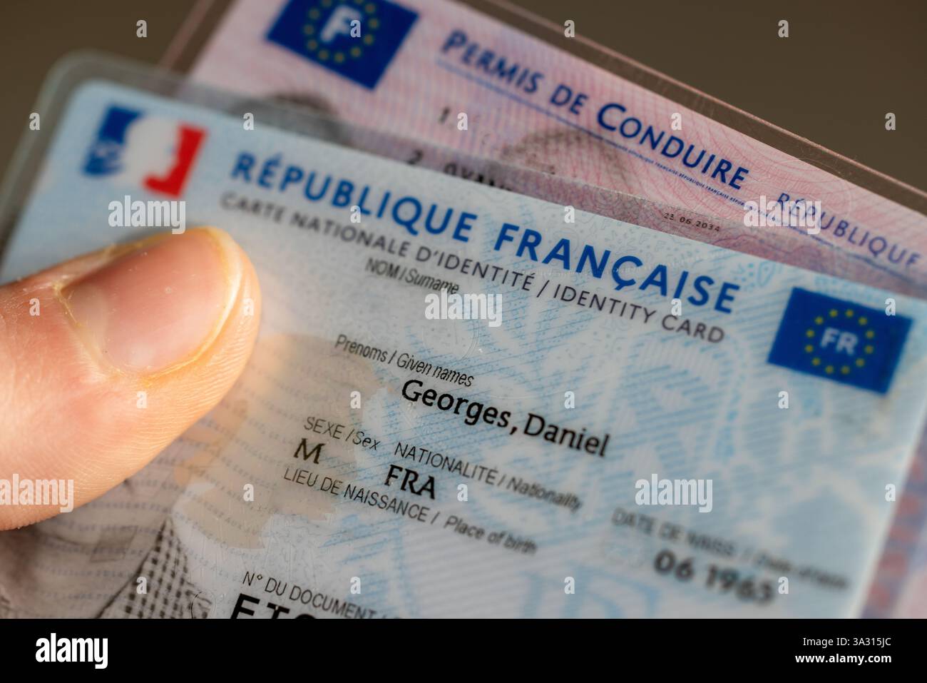 Paris, France - March 13, 2025 : Person holding their driver's license ...