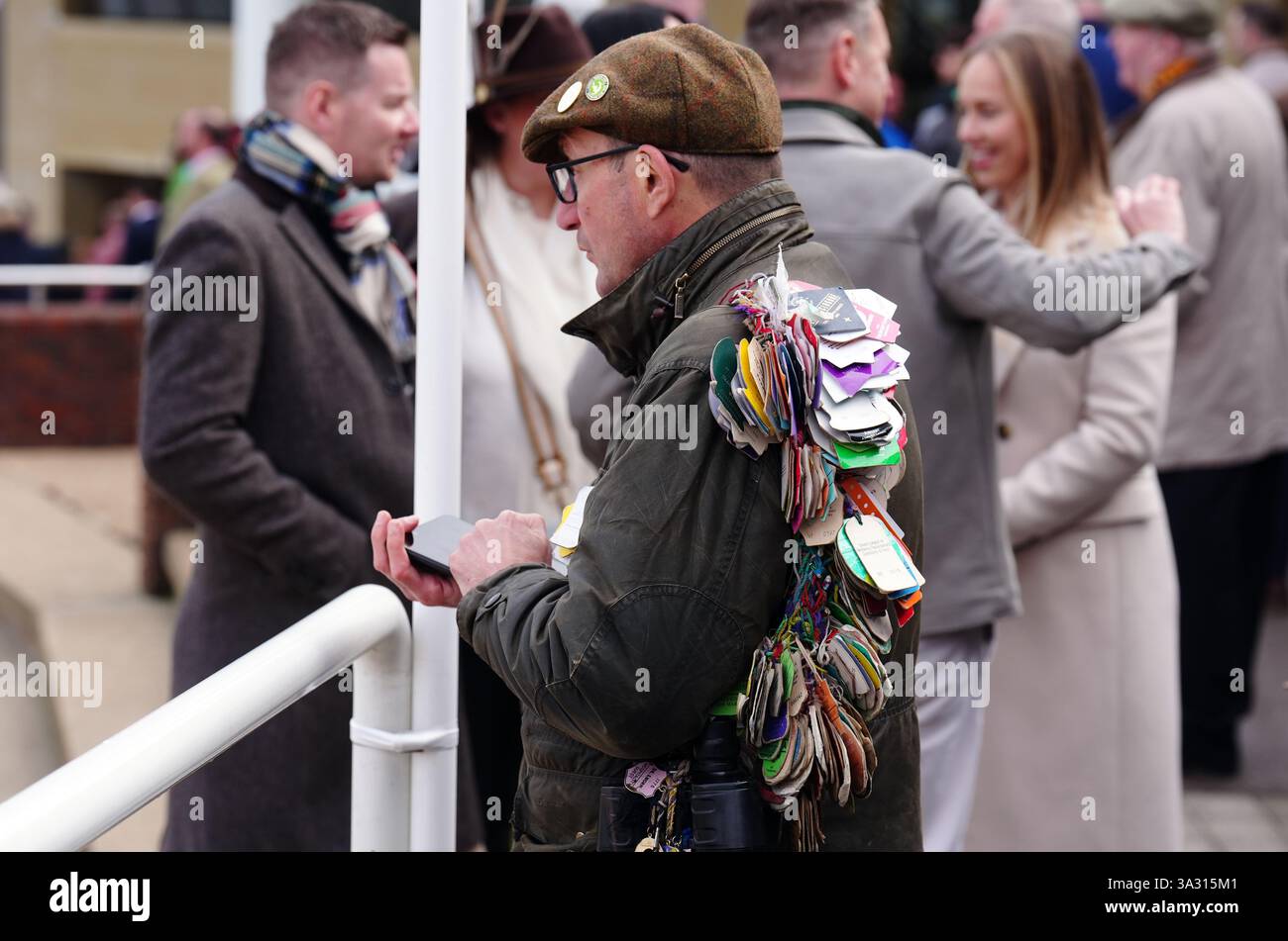 A racegoer with a collection of racing badges on day four of the 2025 ...