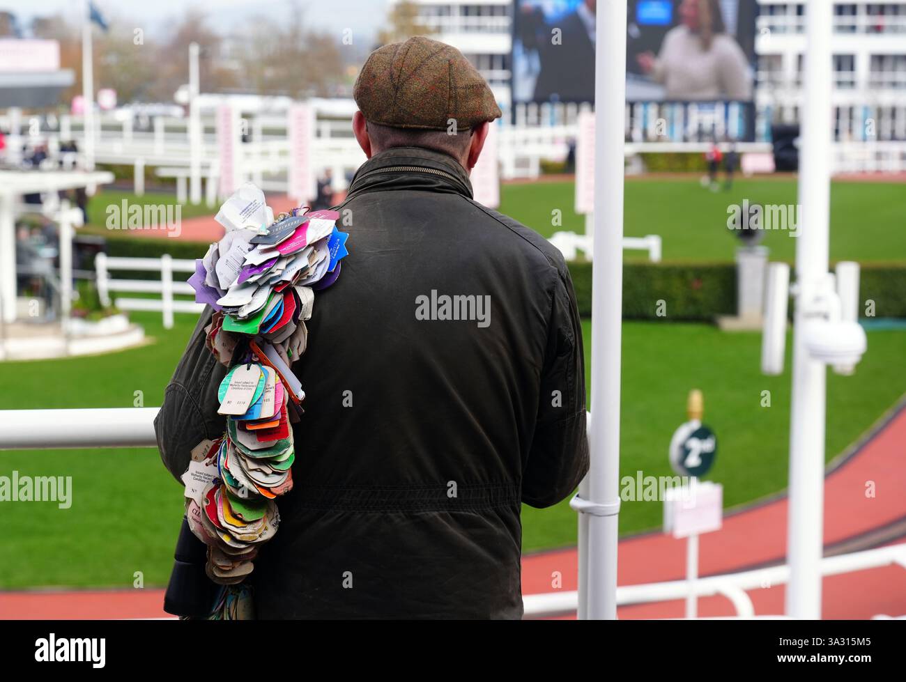 A racegoer with a collection of racing badges on day four of the 2025 ...
