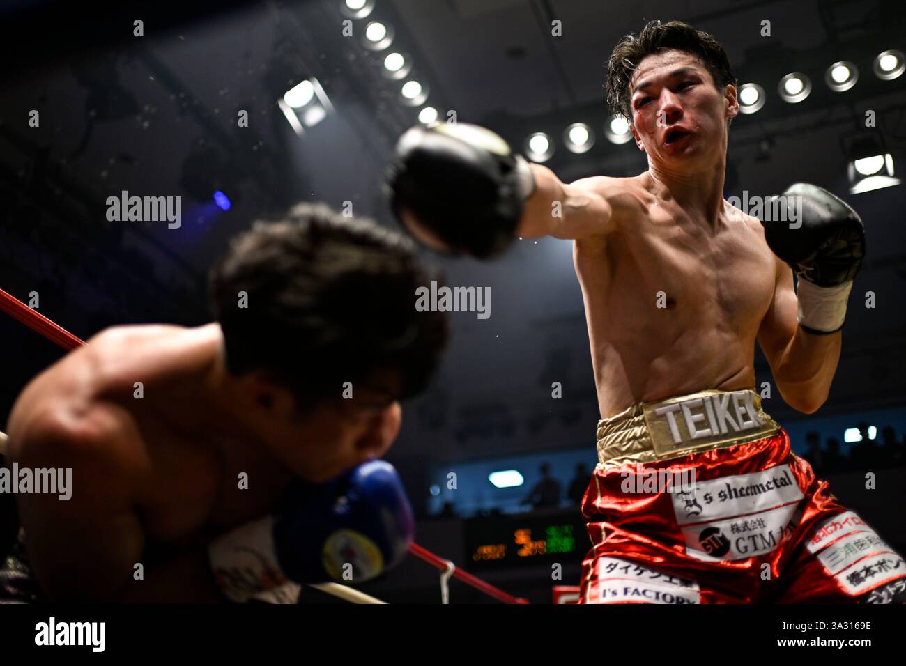 Tokyo, Japan. 1st Mar, 2025. Champion Kuntae Lee (black gloves) throws a right at challenger ...
