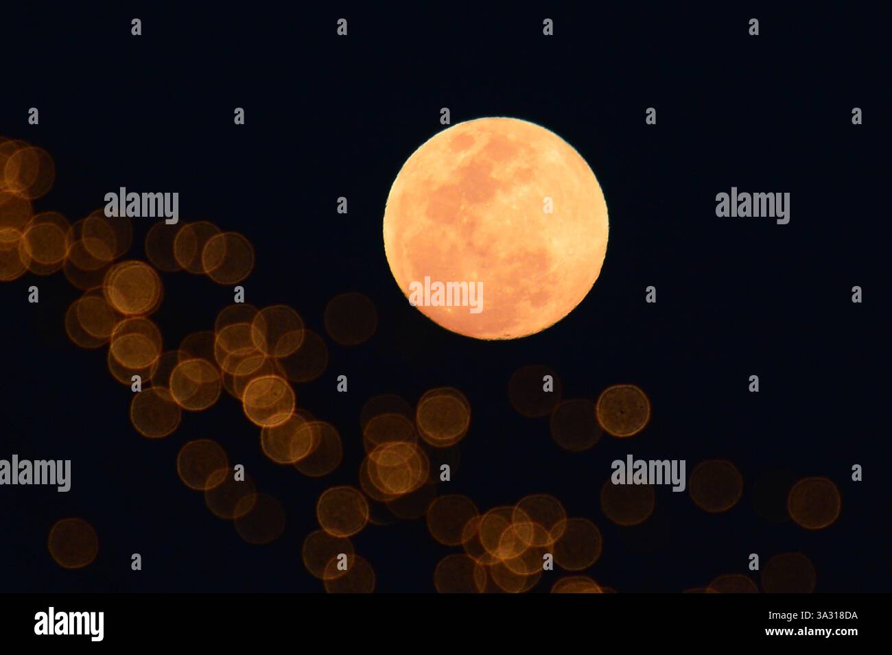 Karachi. 13th Mar, 2025. The full moon rises over the southern ...