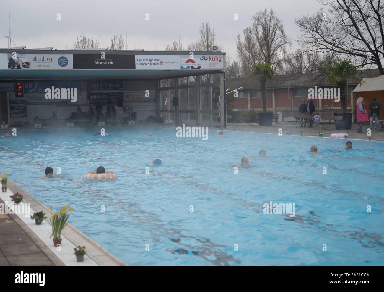 Karlsruhe, Germany. 14th Mar, 2025. Numerous bathers swim in the ...